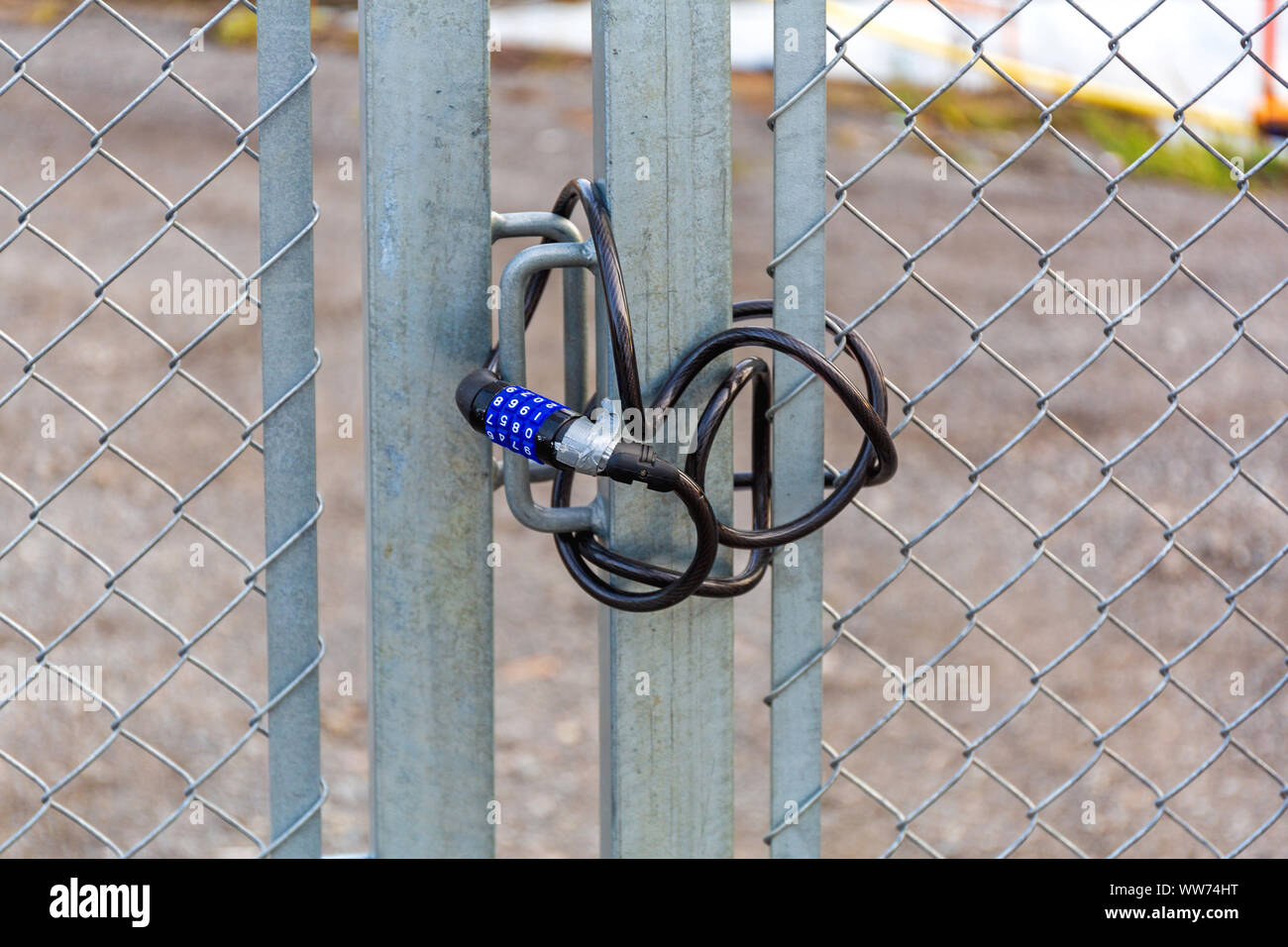 Combination Lock Wire at Construction Site Barrier Stock Photo - Alamy