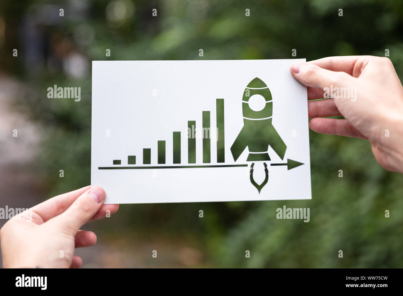 Hands Holding Paper With Cutout Growth Chart Outdoors Stock Photo - Alamy
