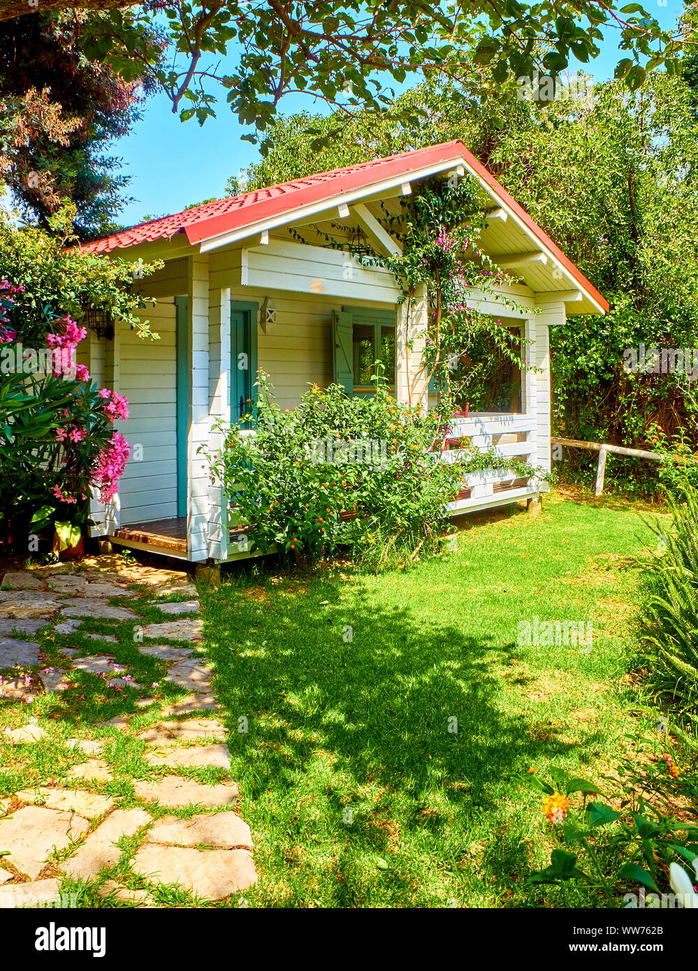Country style wooden bungalow in the middle of a garden Stock Photo - Alamy