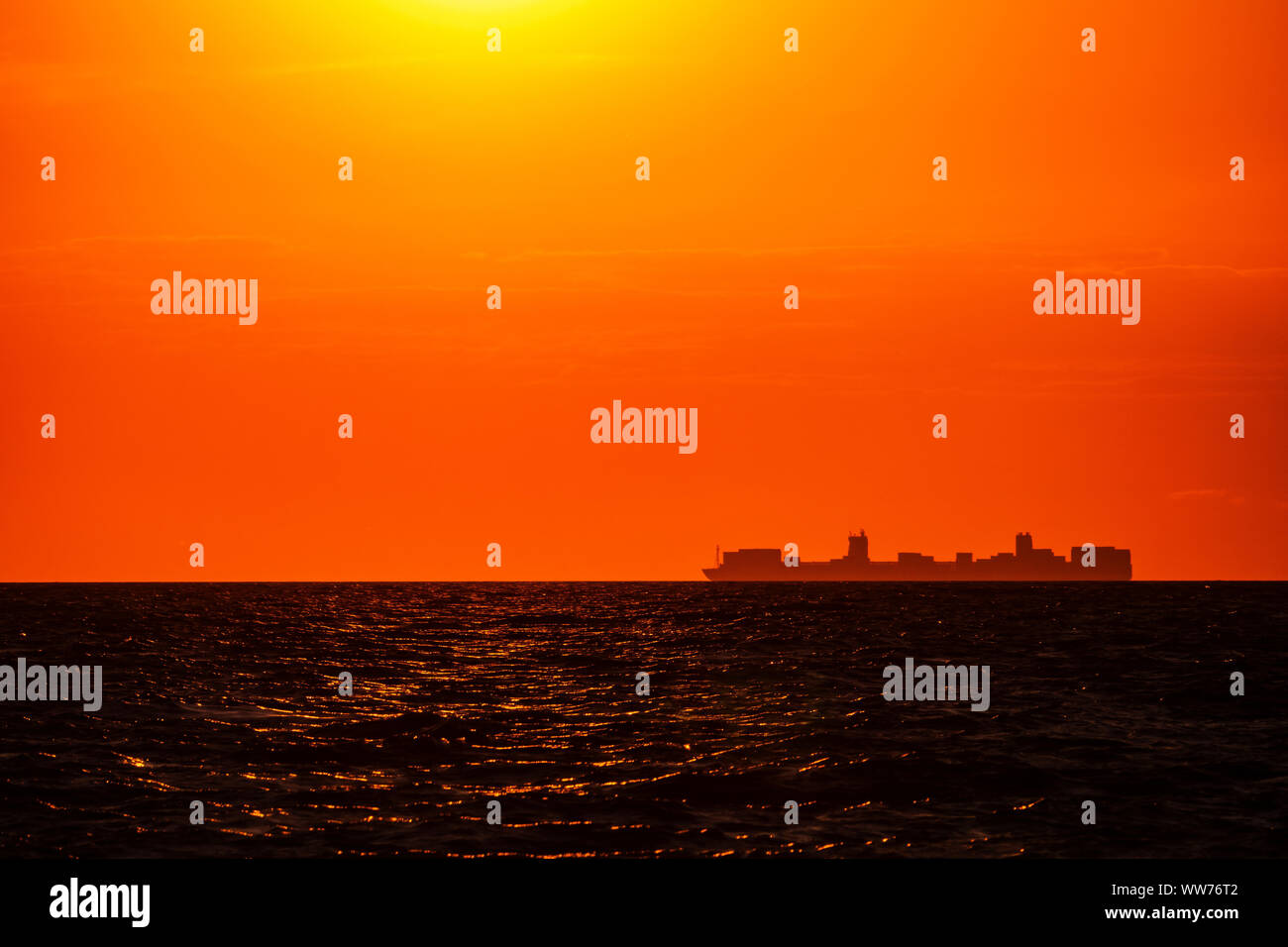 Cargo ship on the baltic sea in the evening light hi-res stock ...