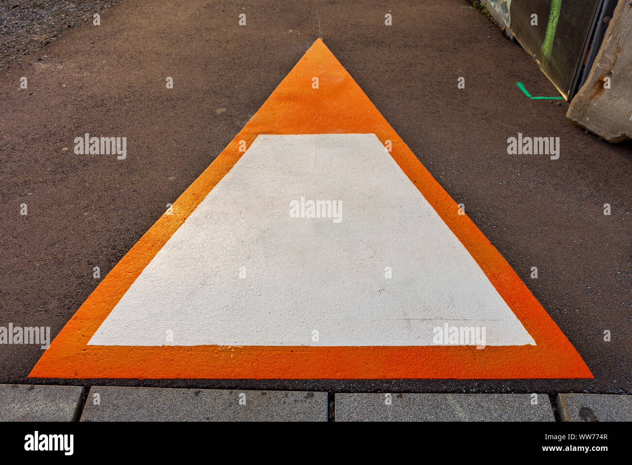 Big Triangle Arrow Paint Sign at Pavement Stock Photo - Alamy