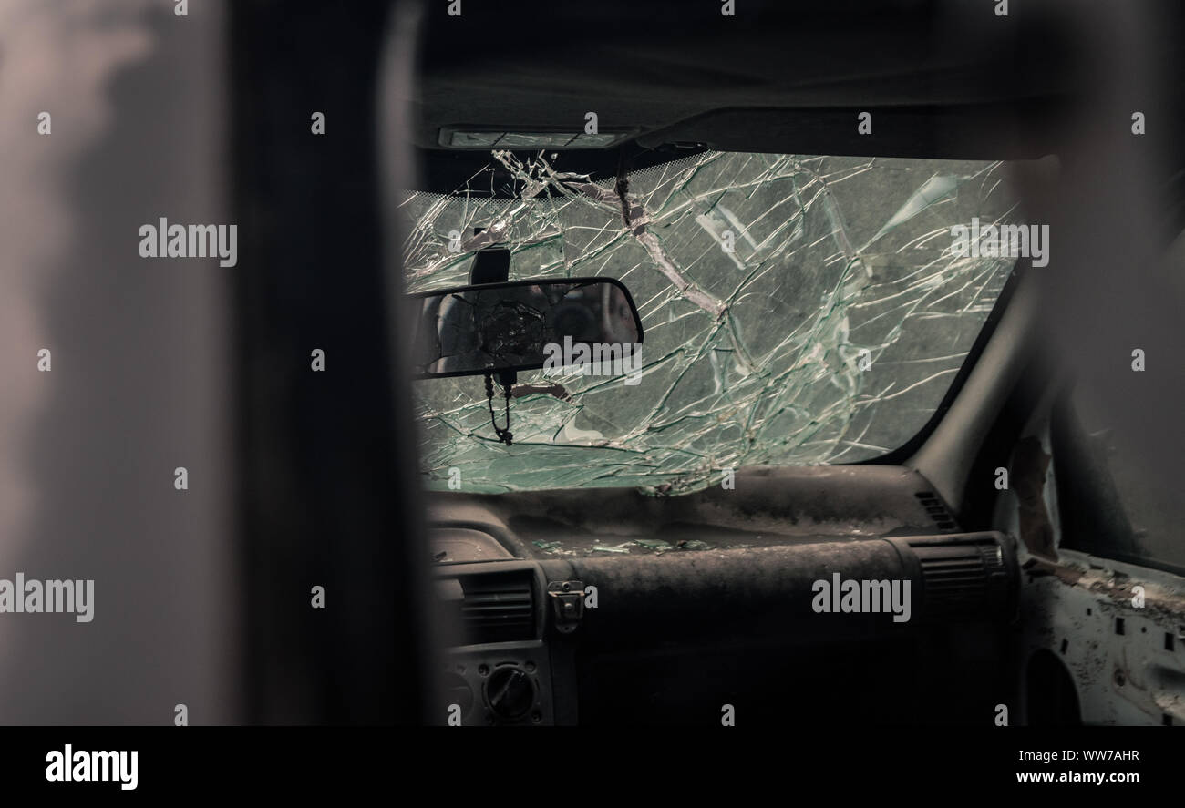 View from inside a car with a shattered windshield. Cracked glass and ...
