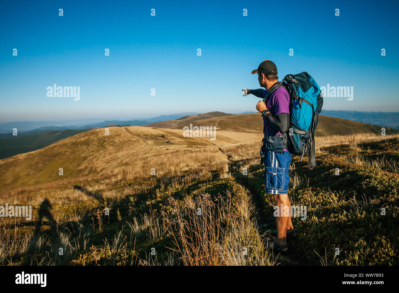 Man goes hiking in the mountains alone Stock Photo - Alamy