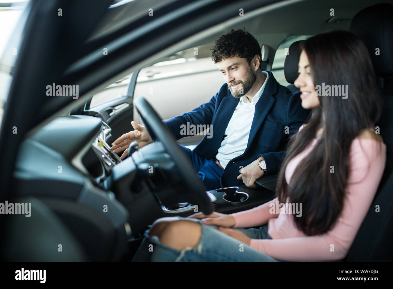 Dealer speaking with a client in a dealership Stock Photo - Alamy