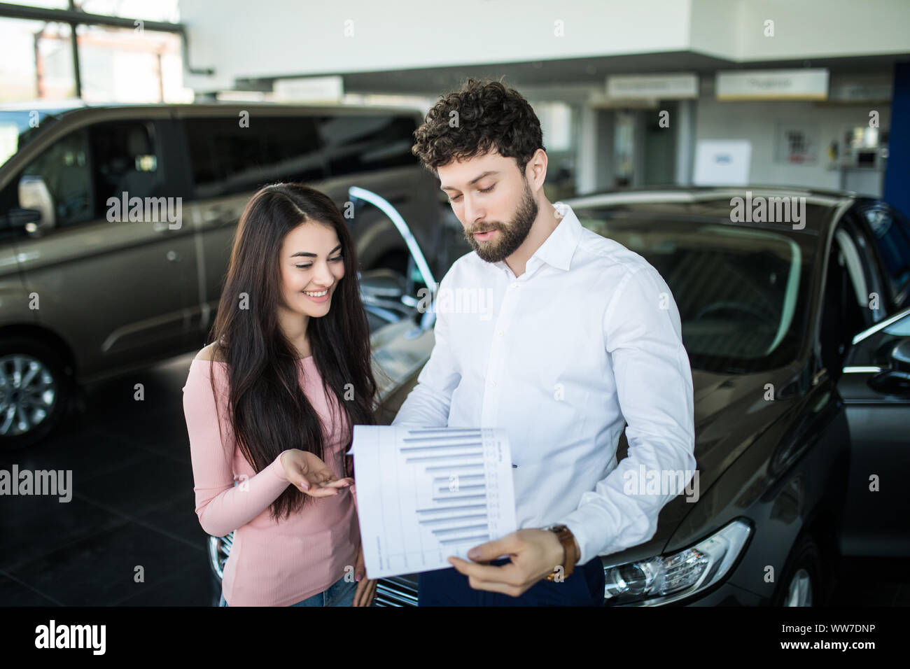 happy woman buying a new car at vehicle showroom Stock Photo - Alamy