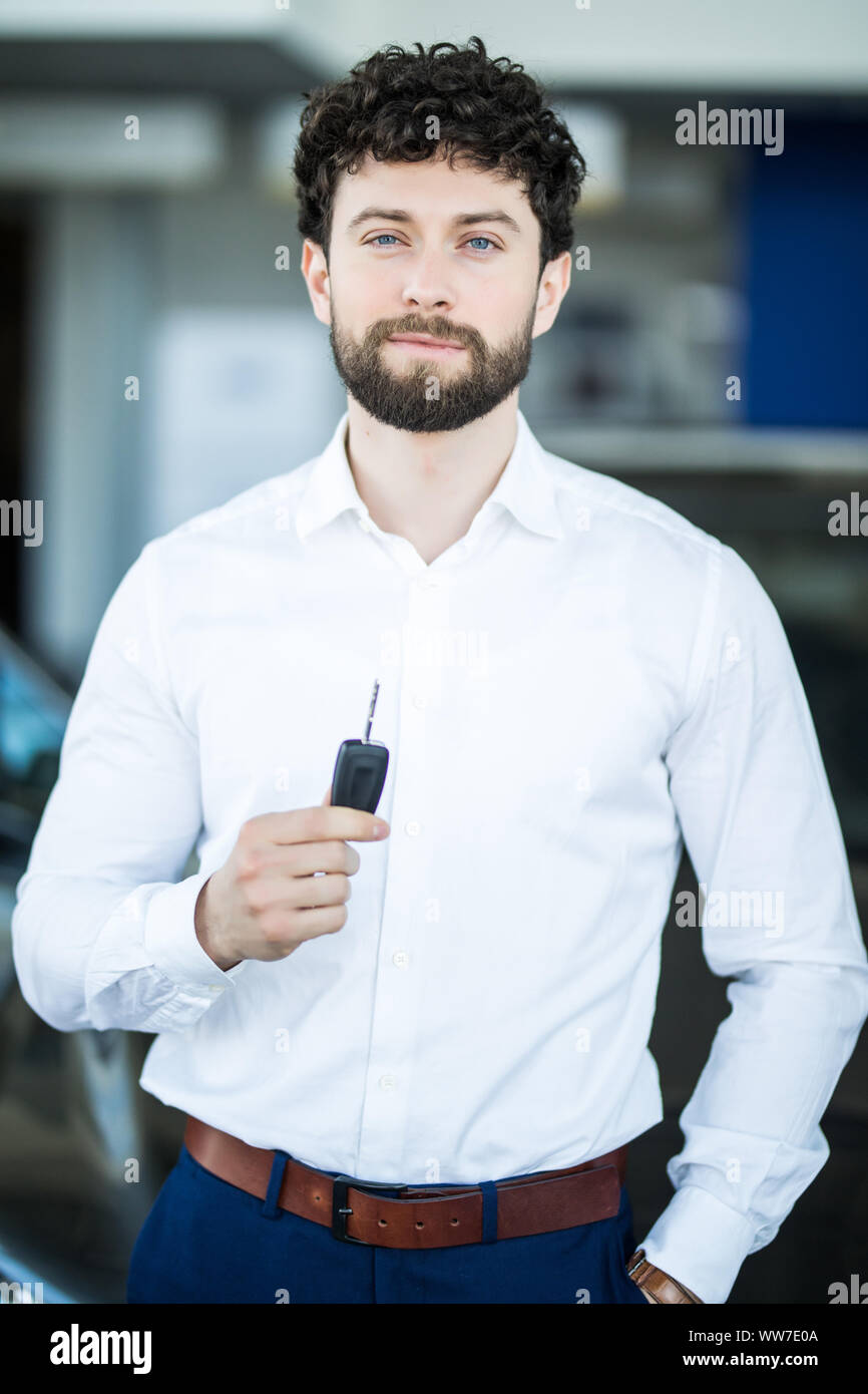 Car Salesman Giving Key of New Car at Showroom Stock Photo - Alamy