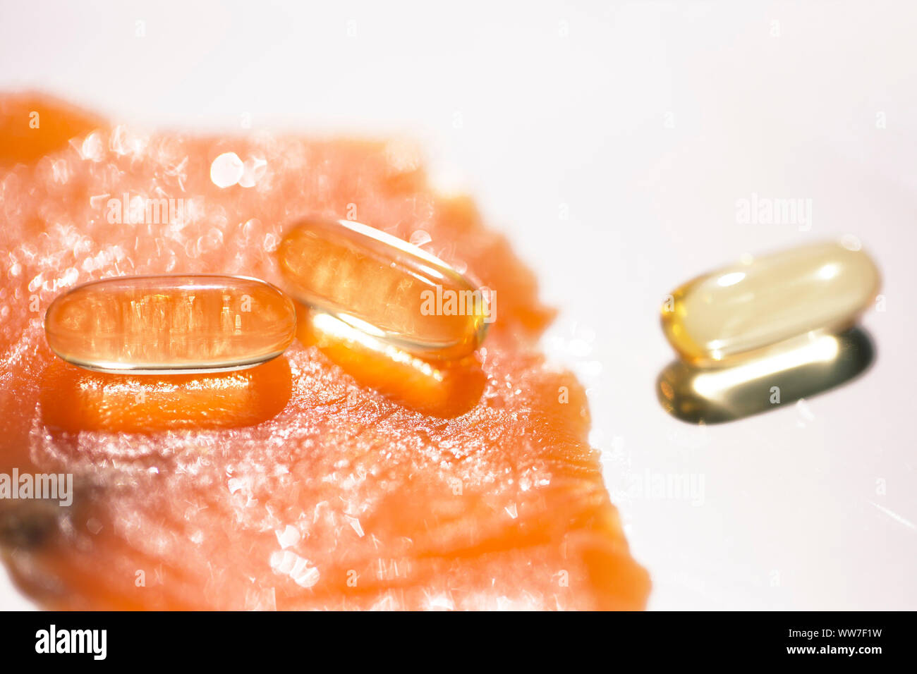 Useful Fish Oil Capsules. Close-up of salmon fillet and pills layout ...