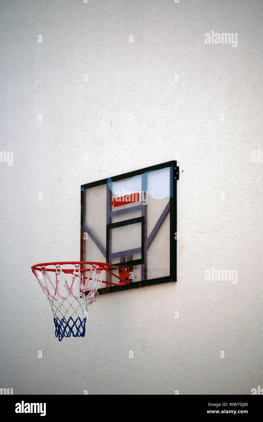 A basketball hoop mounted to the house wall of a residential building ...