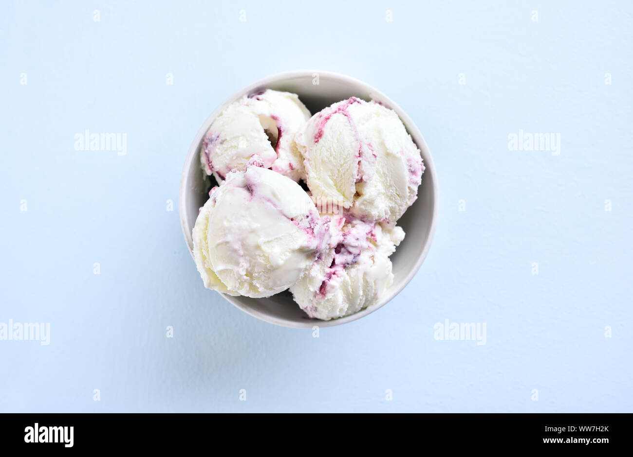Vanilla blueberry ice cream in bowl on blue stone background with free ...
