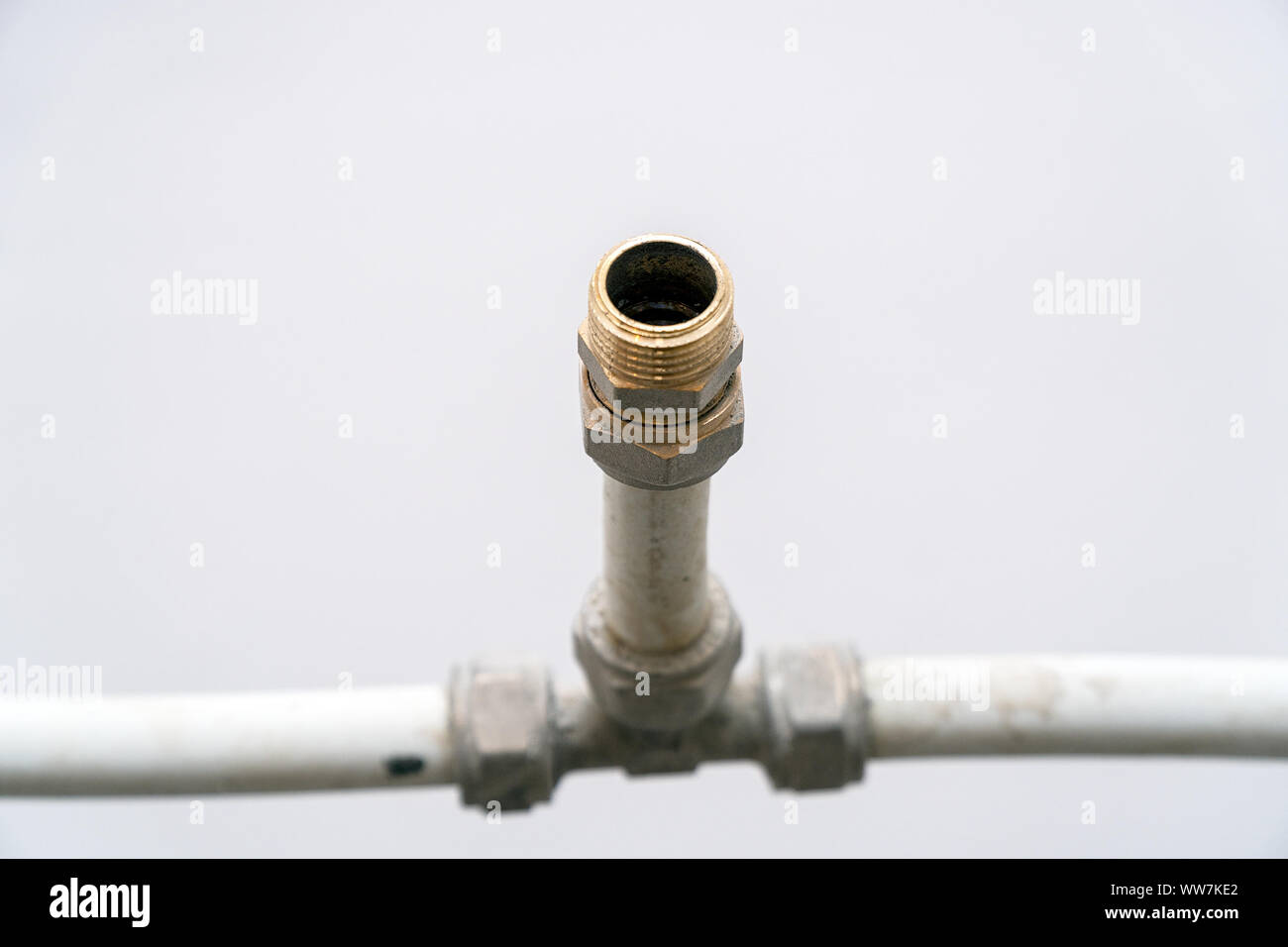 Old connection fitting tee on plastic water pipes Stock Photo - Alamy