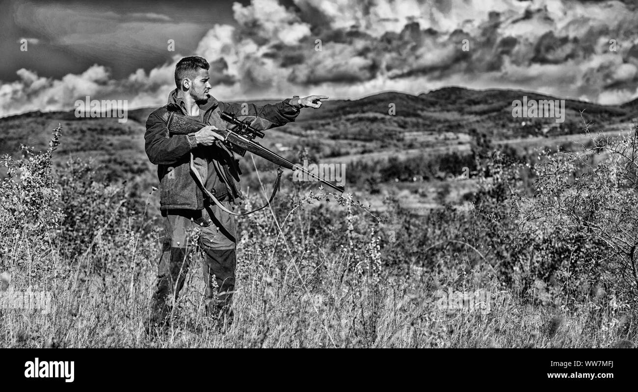 Man hunter aiming rifle nature background. Experience and practice ...