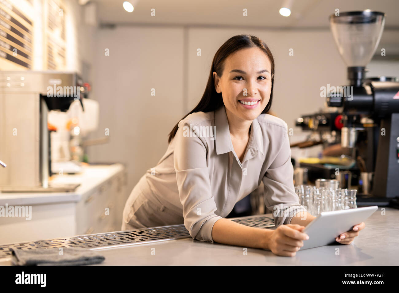 Happy young female barista hi-res stock photography and images - Alamy
