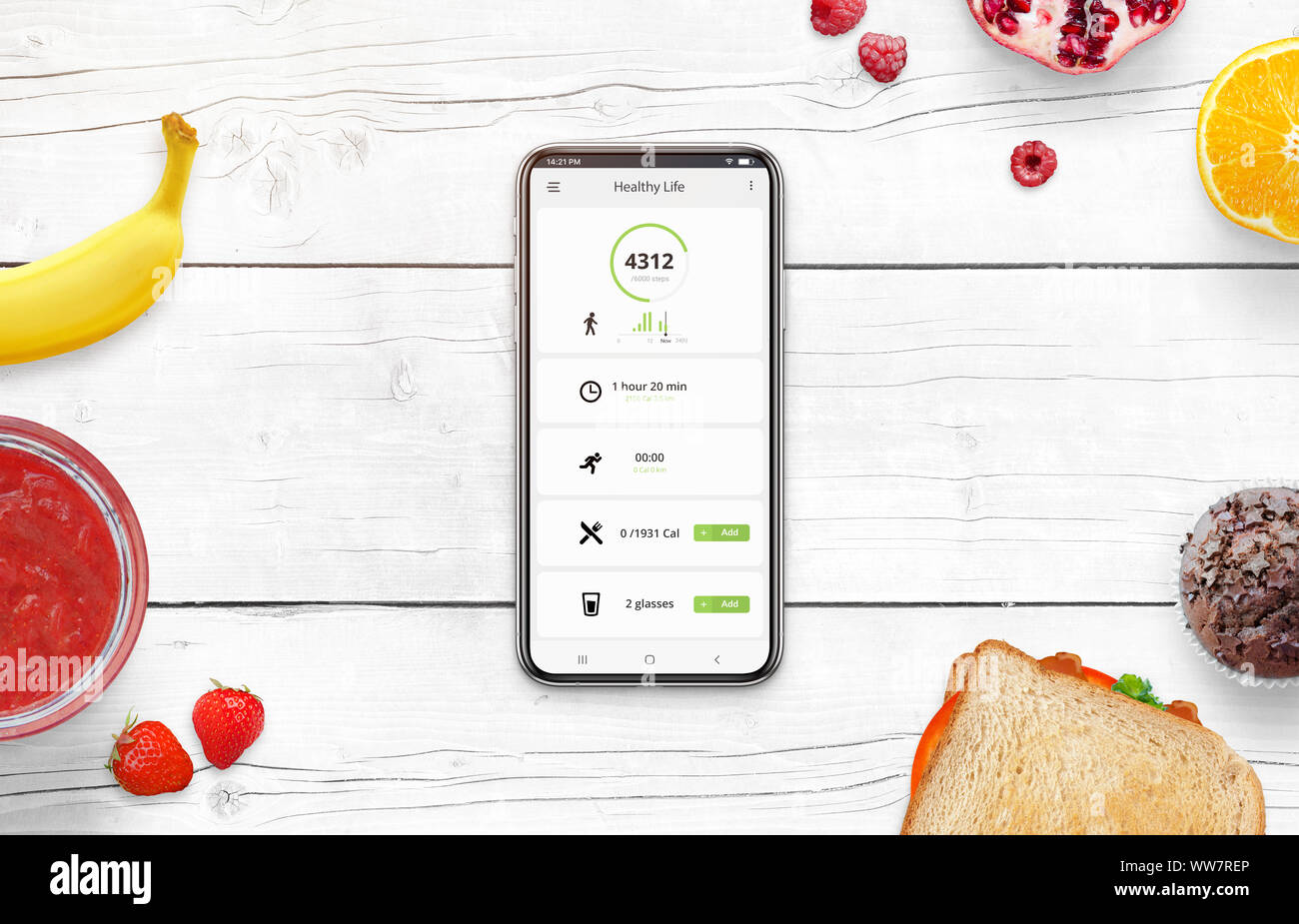 Phone on desk surrounded with food. Healthy life app concept with daily ...