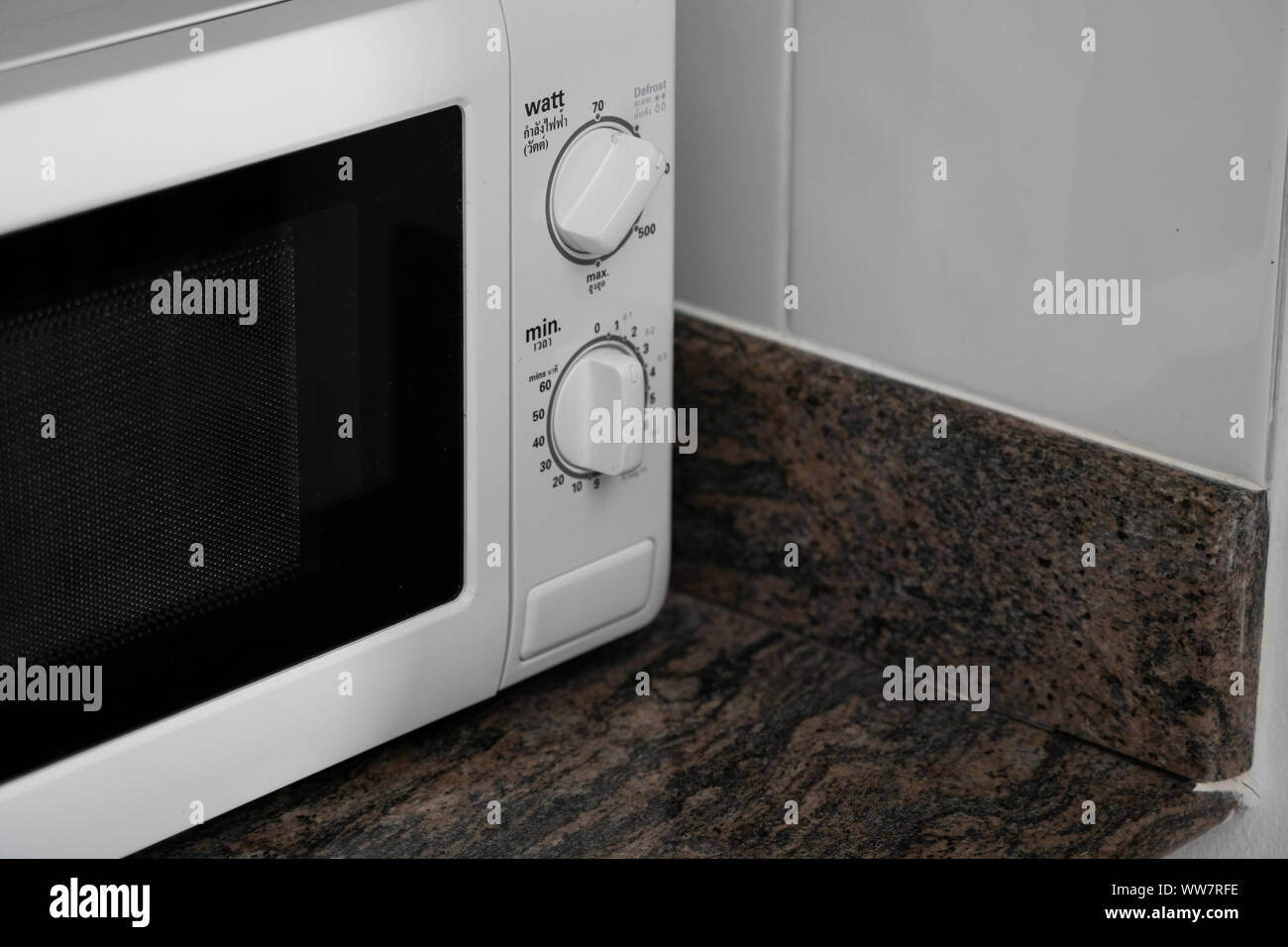 Microwave in a kitchen for cooking or heating a dish Stock Photo - Alamy