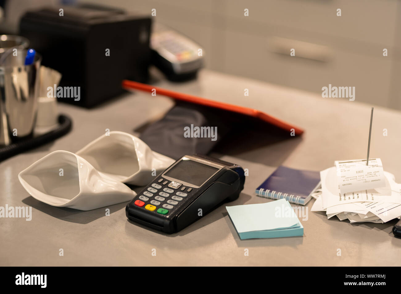 Payment machine, small empty sacks for change, notepapers and stack of ...