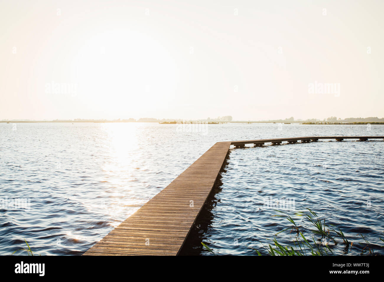 Wooden jetty over water Stock Photo - Alamy
