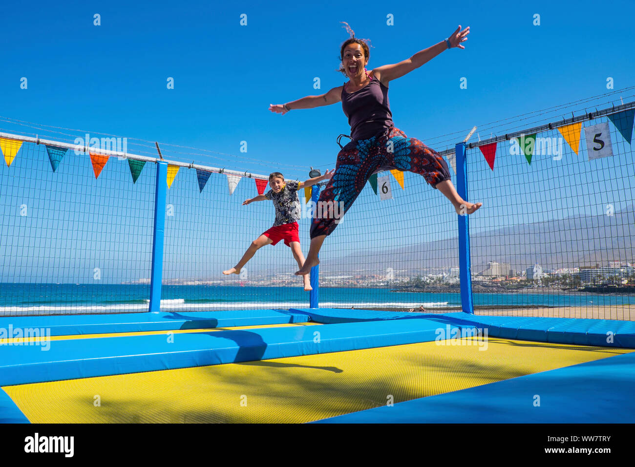 mother and young child son caucasian playing and jumping like crazy ...