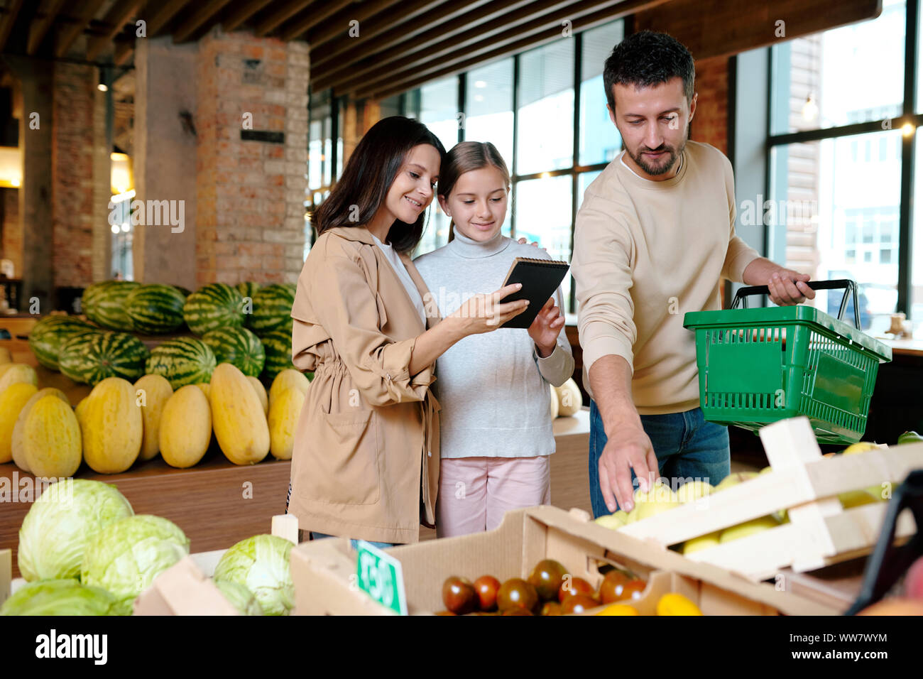 Happy mother and daughter reading points of shopping list in ...