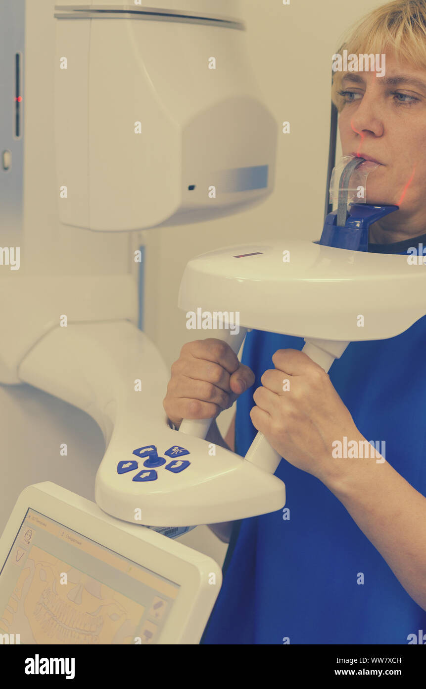 A 45 50-year-old woman undergoes an X-ray examination of the upper and ...
