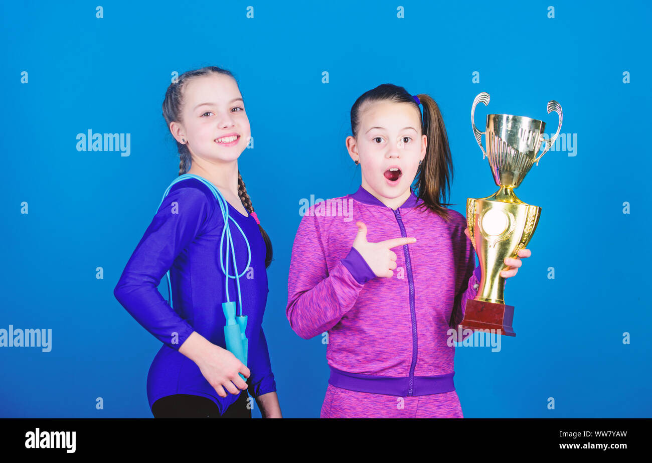 Happy children with gold champion cup. Acrobatics and gymnastics ...