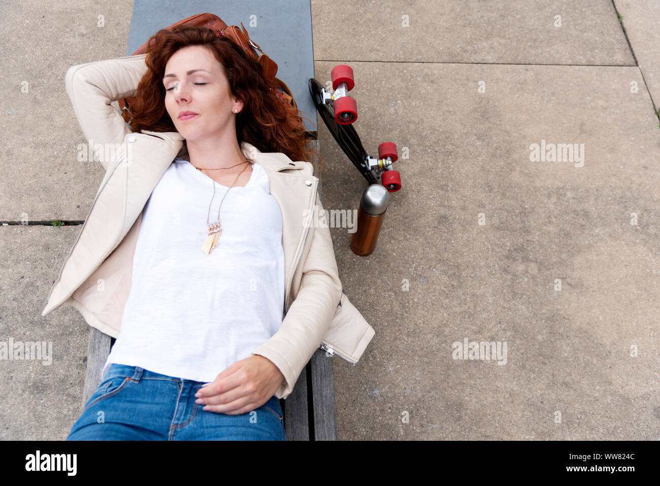 Young woman resting on a bench Stock Photo - Alamy Young woman resting on a bench Stock Photo - Alamy