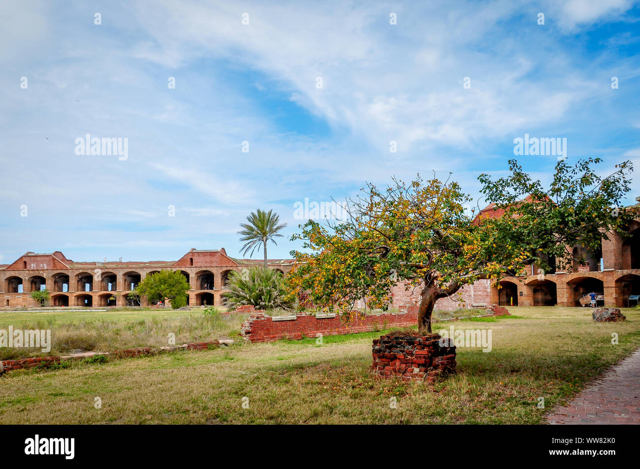 Courtyard of Fort Jefferson with trees and green grass, brick walls ...