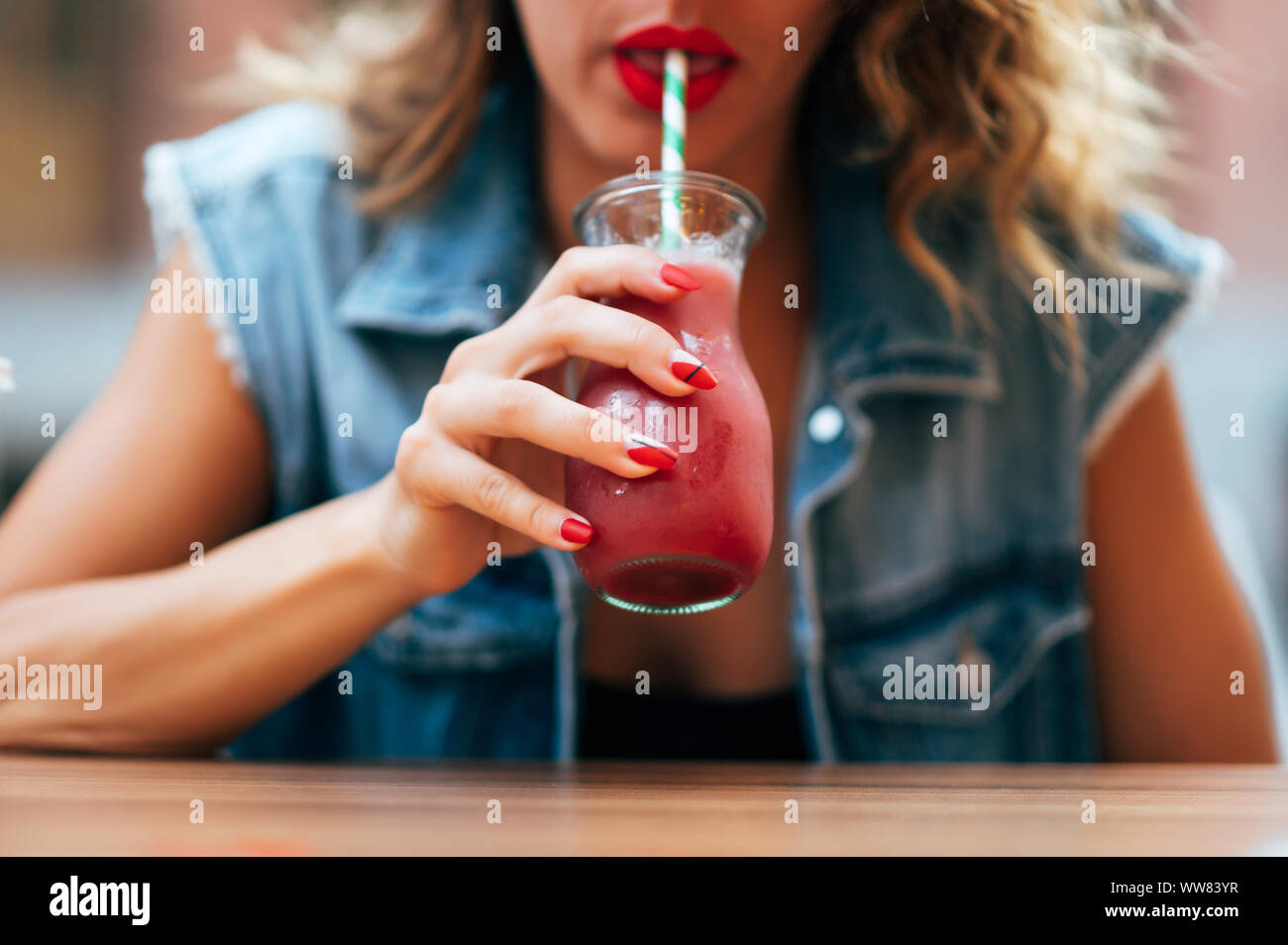 Pretty woman red lips drinking a cocktail soda Stock Photo - Alamy