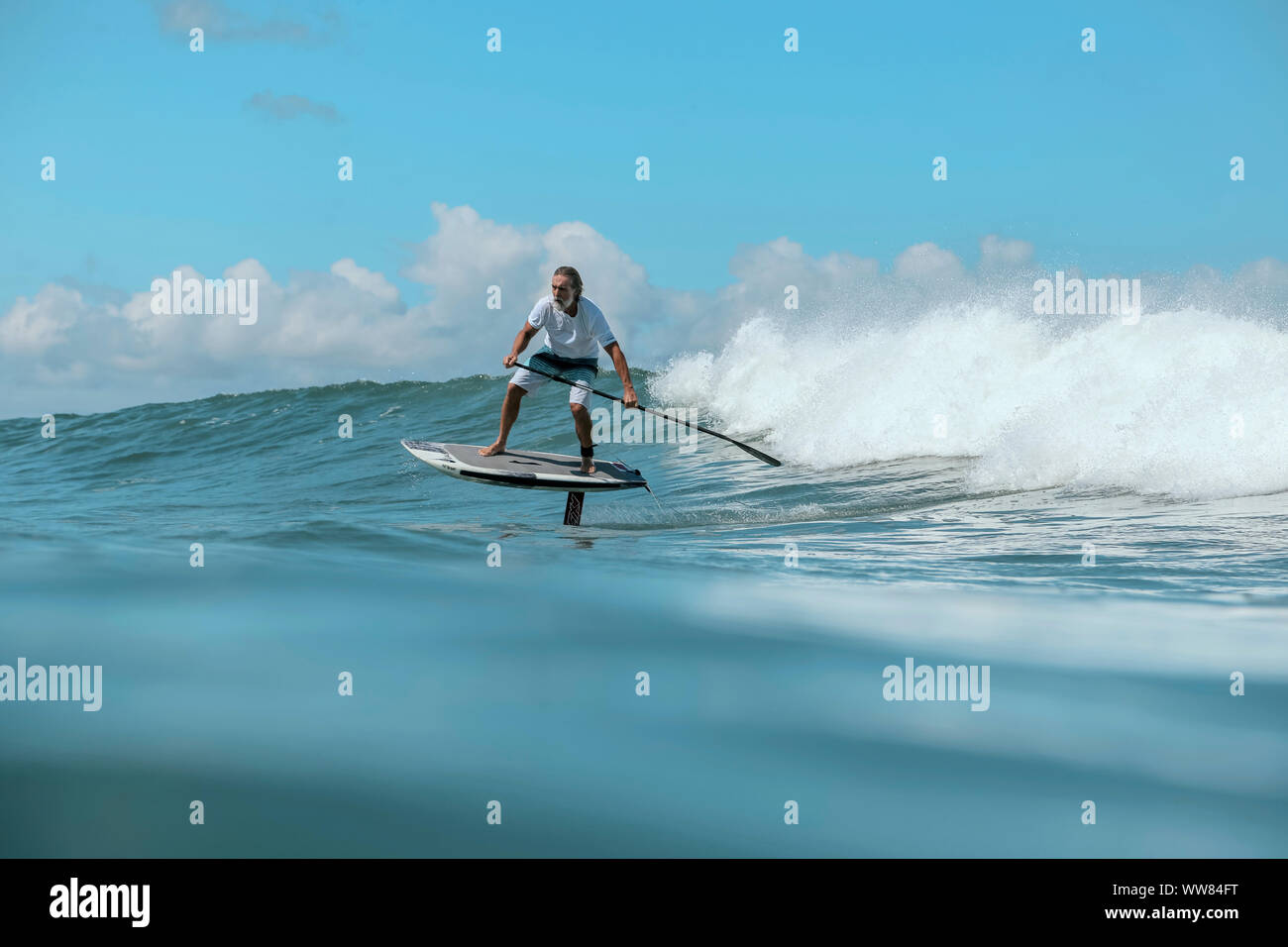 Mature foil surfer Stock Photo - Alamy