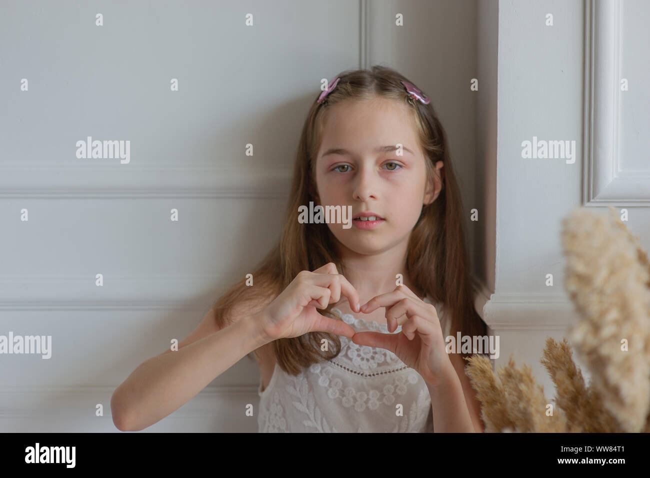 Beautiful little girl shows with gestures 'I love you'.A girl shows ...