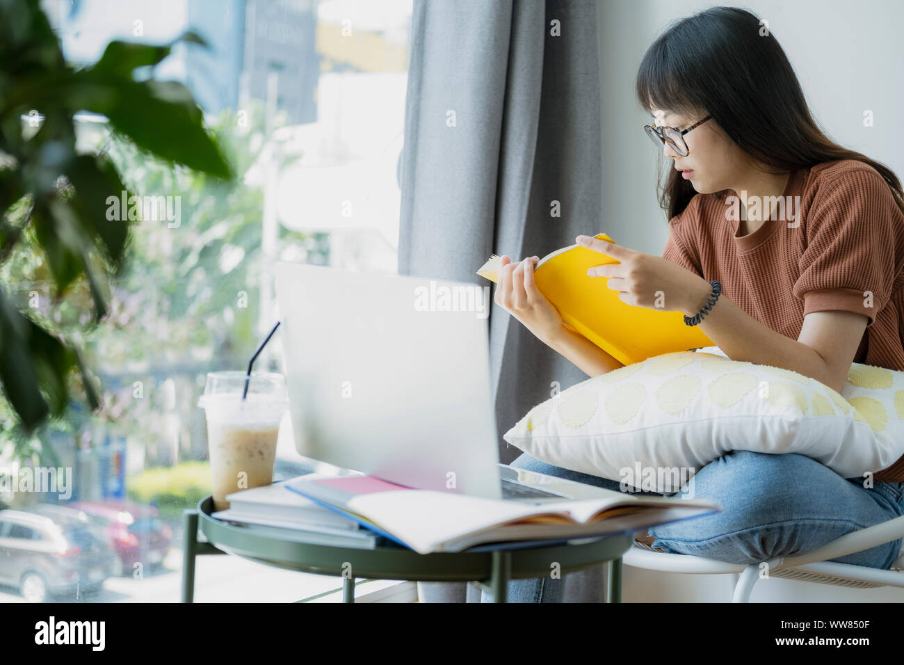Collage student female reading and researching form book. Education and ...