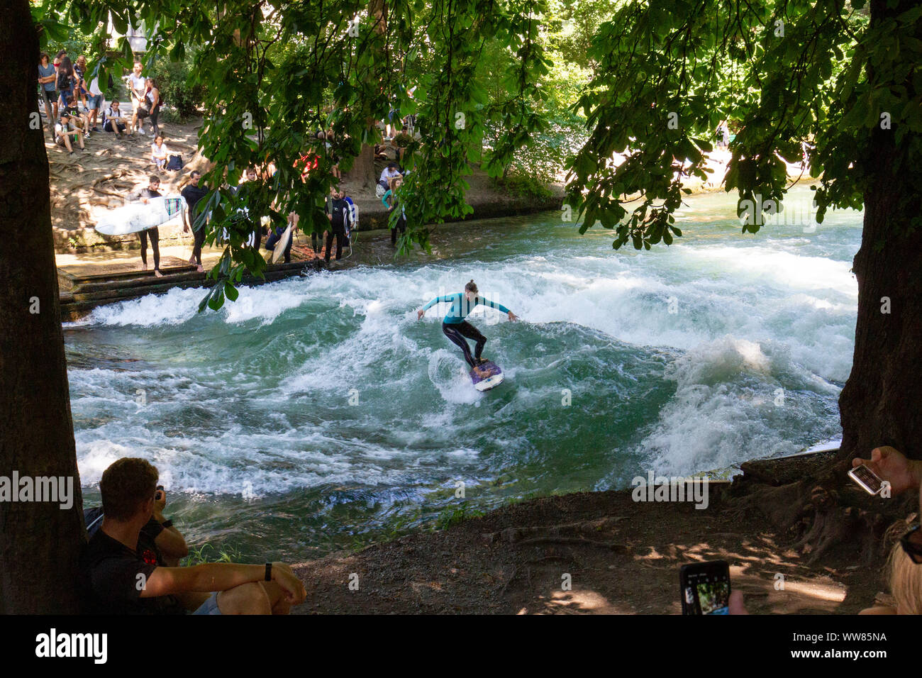 River Wave surfing on the Eisbach, which flows through Englischer ...