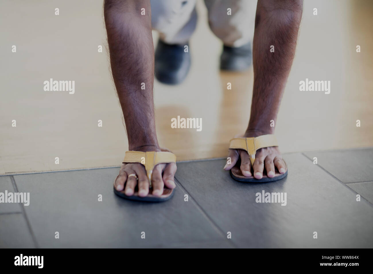 man with sandals in the hands walking Stock Photo - Alamy