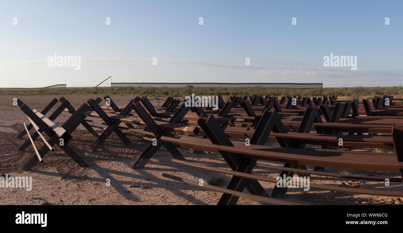 Vehicle barriers removed from the border sit in the foreground as U.S ...