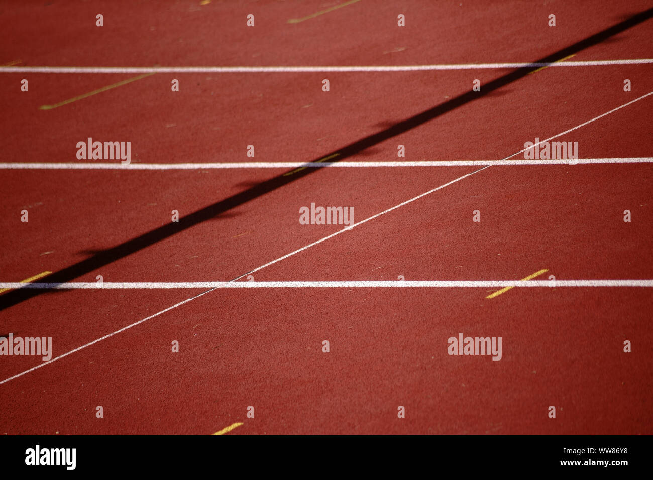 Close up tilted perspective on 100 track in stadium with markings hi ...