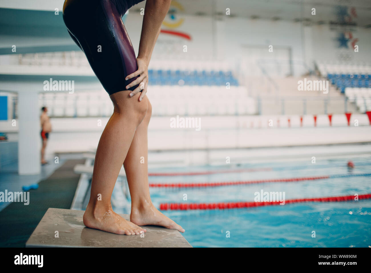 Young woman swimmer getting ready for competition and swim in swimming ...