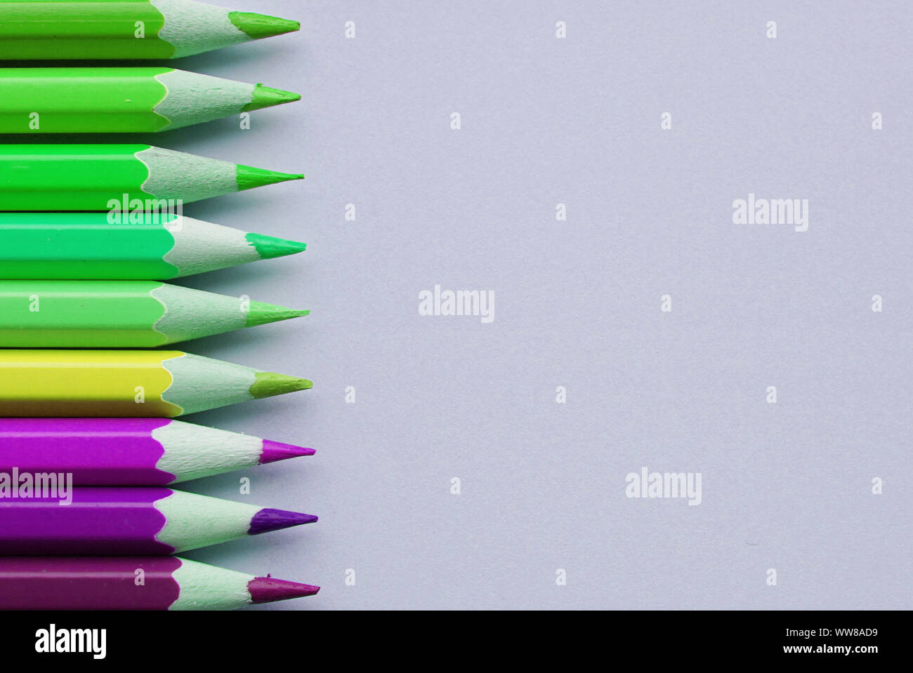 Bright and sharp contrast pencils on gray background with place for ...