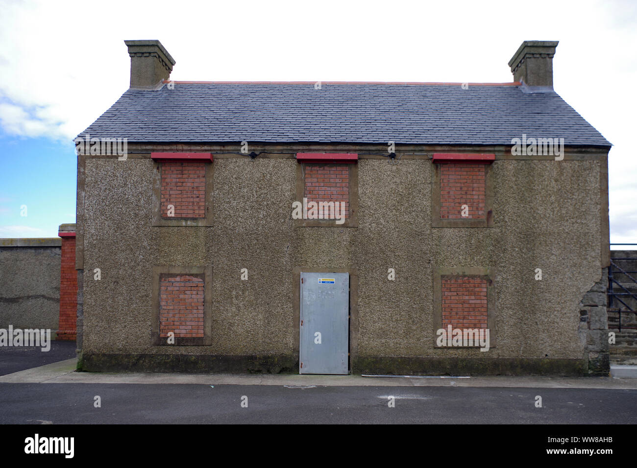 Disused building at Saltcoats Harbour, windows all bricked up. The ...