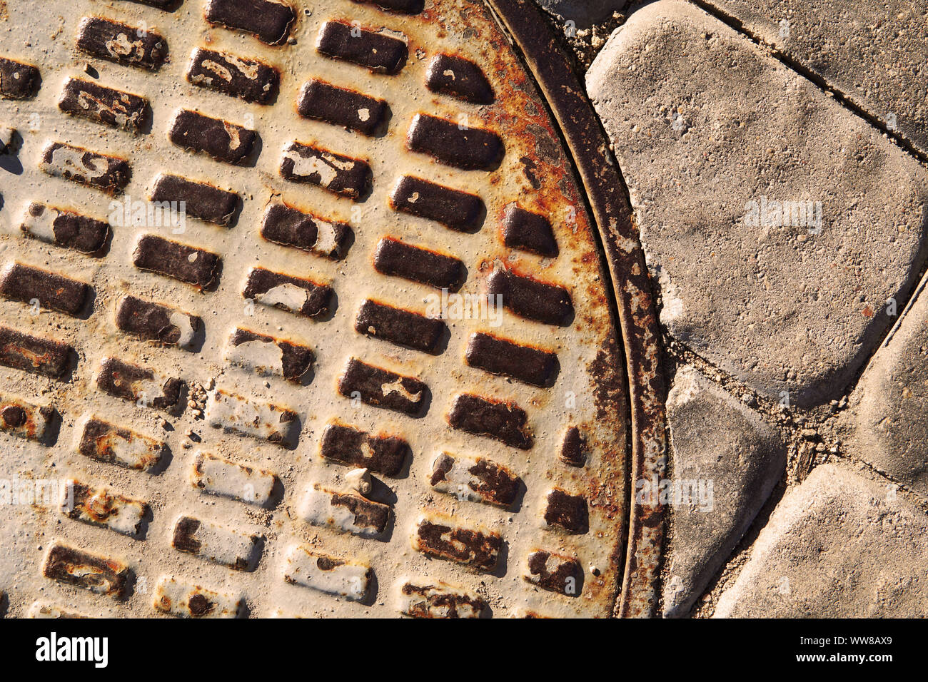 Abstract background of rusty manhole cover and paving tiles Stock Photo ...