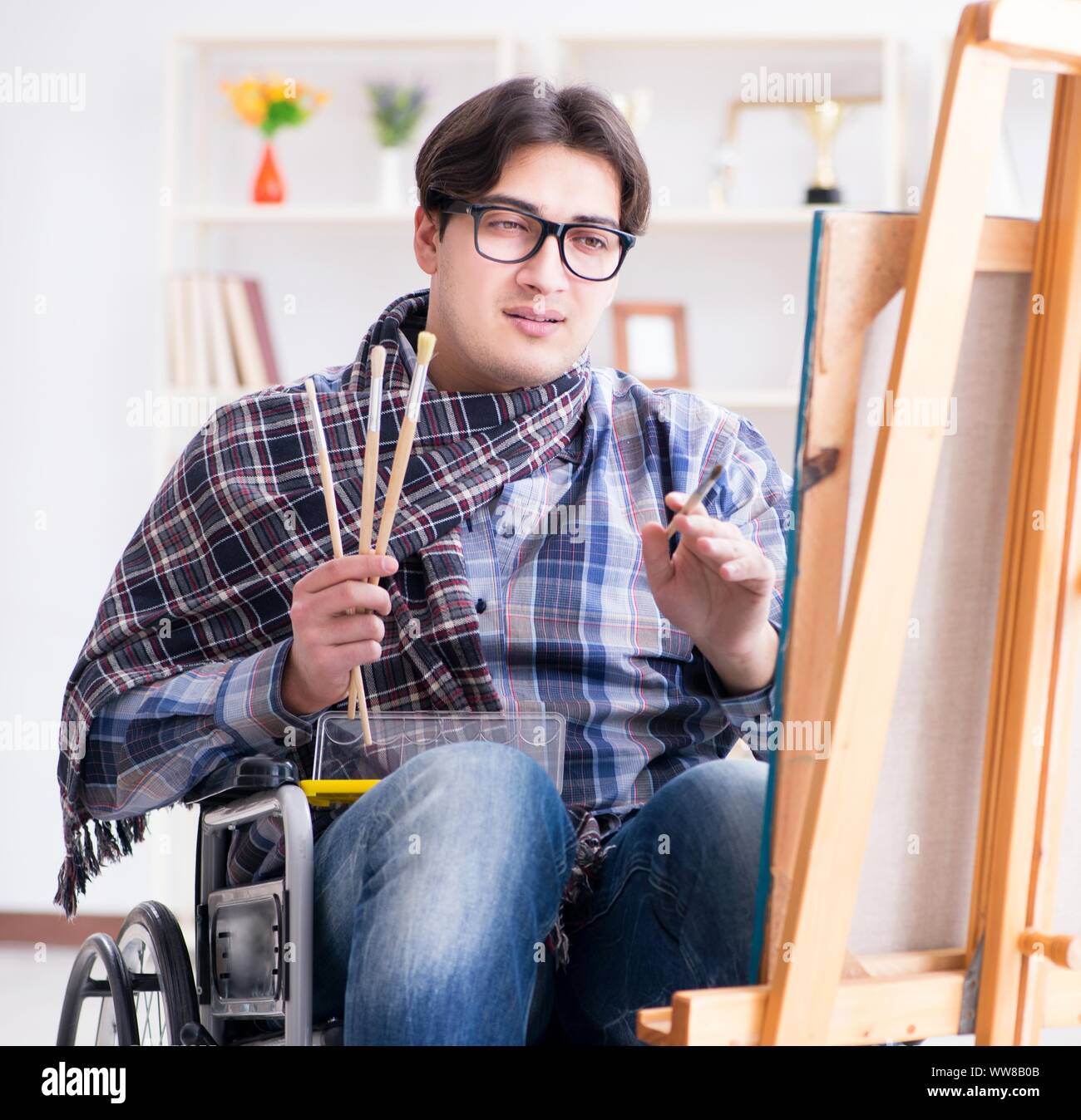 The disabled artist painting picture in studio Stock Photo - Alamy