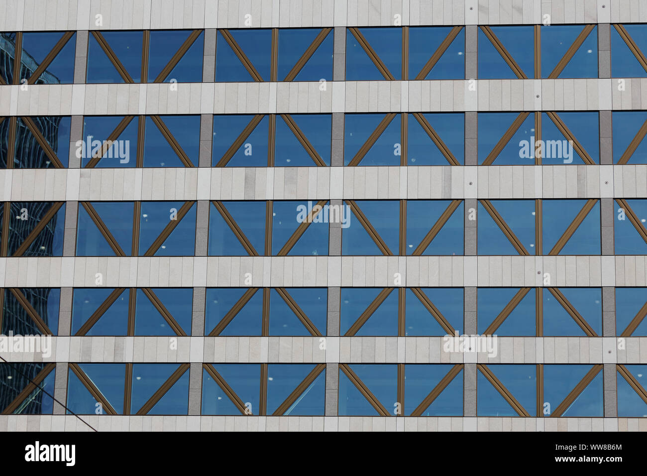 Modern office building with large windows and with crisscrossing beams ...