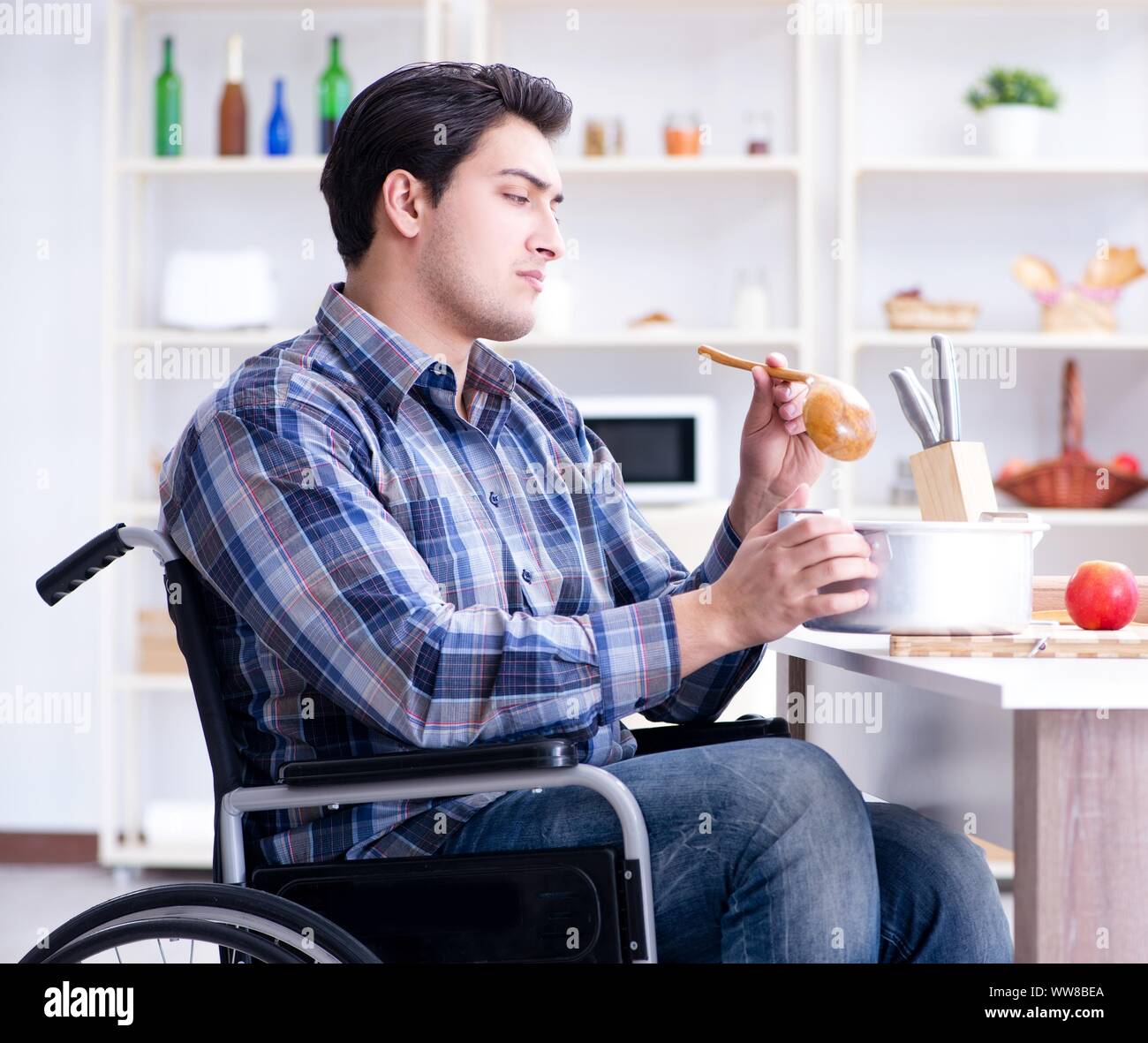 The disabled man preparing soup at kitchen Stock Photo - Alamy