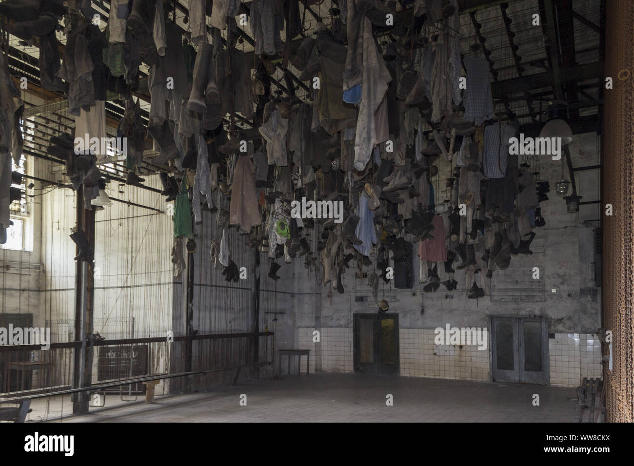 Mining clothing and boots in mining dressing room and chains Stock ...