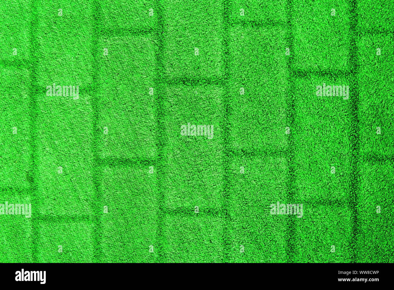 Green grass background with a brick wall texture Stock Photo - Alamy