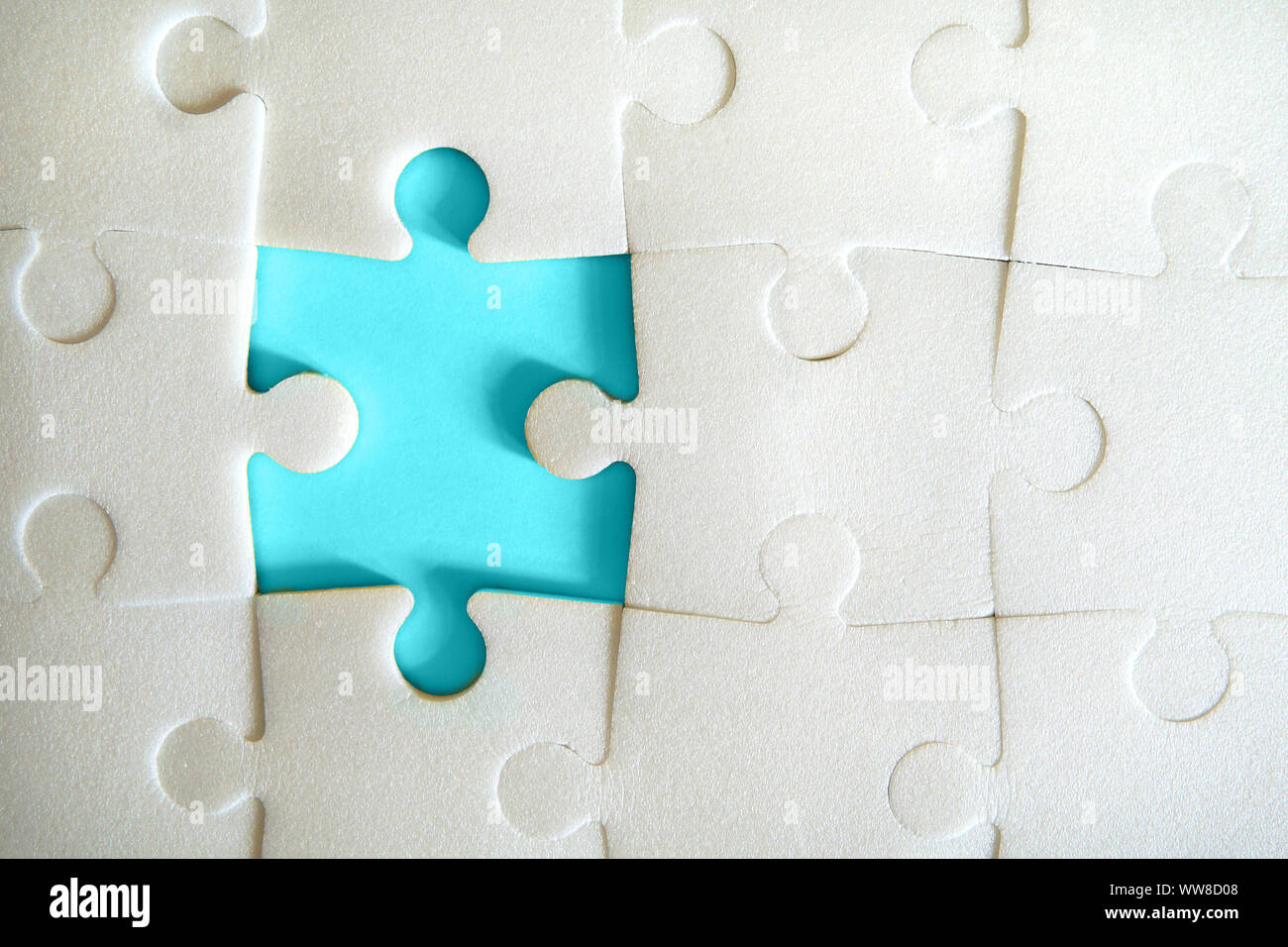 Multiple white puzzle pieces put together without one piece. View from ...