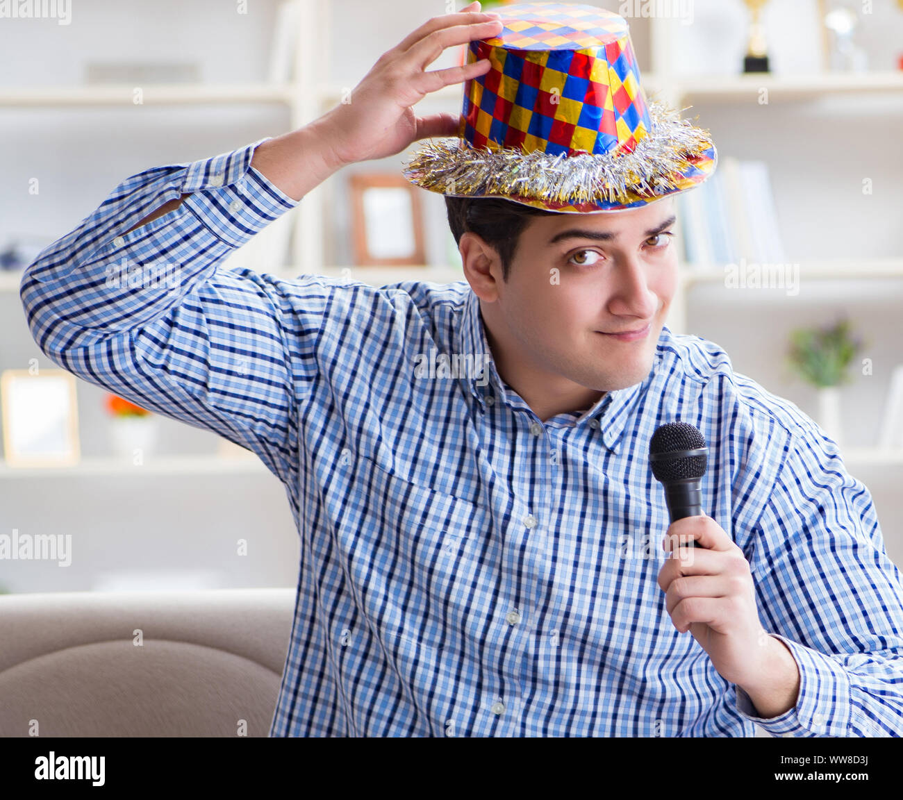 The funny man singing songs in karaoke at home Stock Photo - Alamy