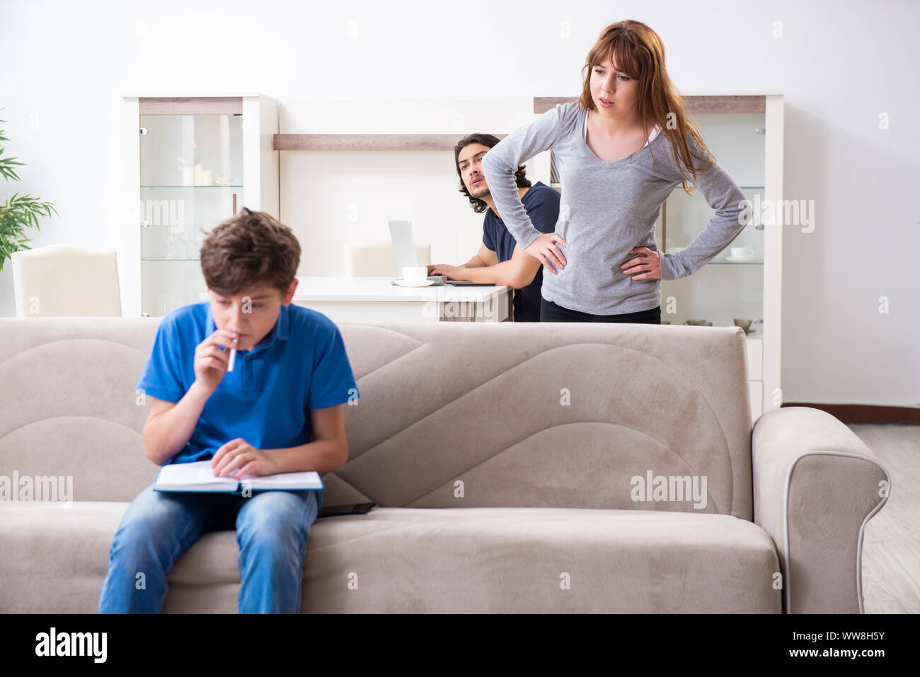 The concept of underage smoking with young boy and family Stock Photo ...