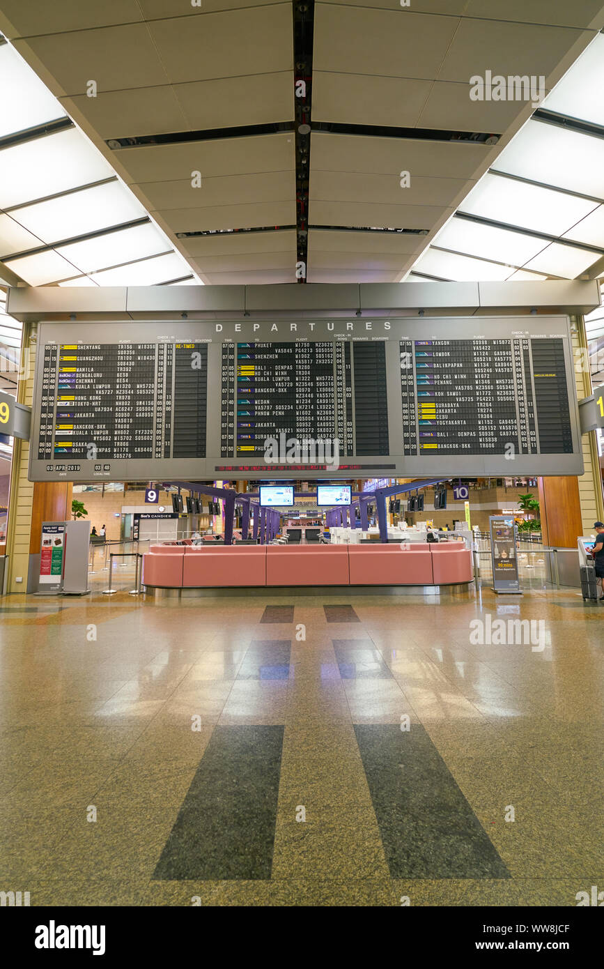 SINGAPORE - CIRCA APRIL, 2019: a flight information display at ...