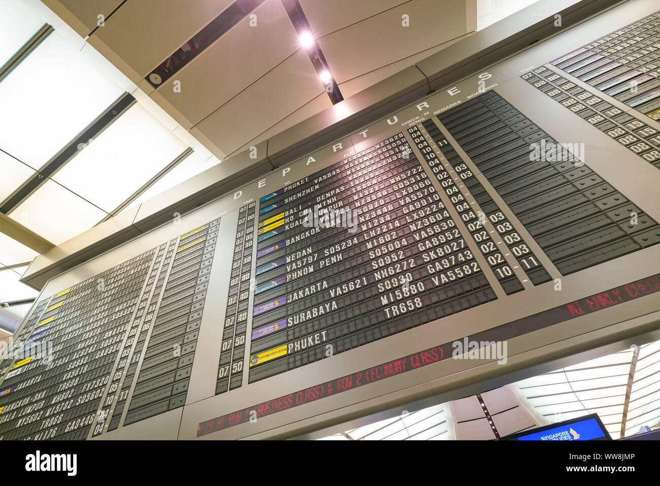 SINGAPORE - CIRCA APRIL, 2019: a flight information display at ...