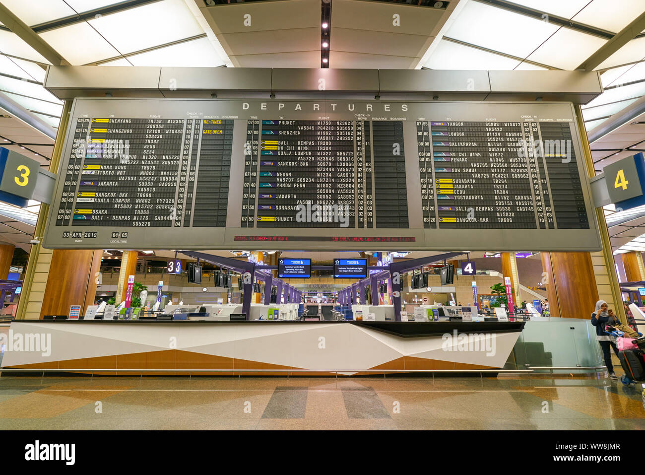 SINGAPORE - CIRCA APRIL, 2019: a flight information display at ...