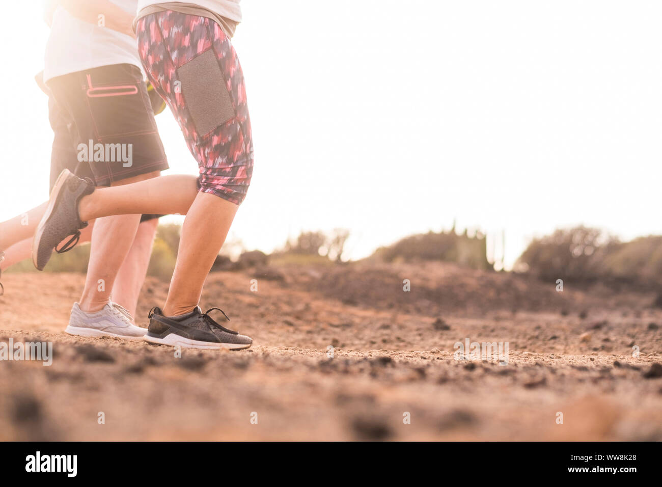 friends running together in a desert ground tropical landscape. summer ...